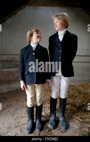 Boys wearing horse riding clothes, smiling Stock Photo - Alamy
