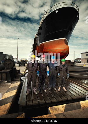 A builder in a blue overalls stands in the shade Stock Photo - Alamy
