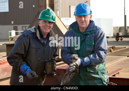 Marine engineer working in ship's workshop in engine control room ECR ...