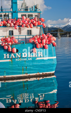 Colorful floats hanging stern of sac roe herring fishery tender docked ...
