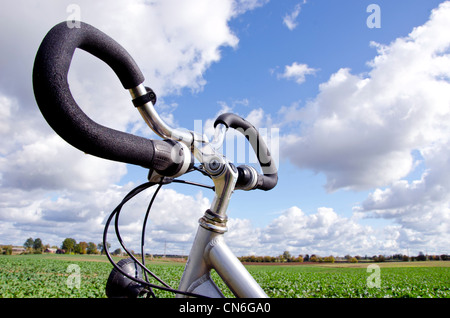 Handlebar of bicycle on background of rural road Stock Photo - Alamy