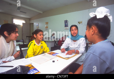 Sikh children in classroom with teacher at gurdwara learning Punjabi ...