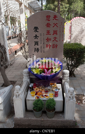 Beijing, Wanan cemetery. Grave with food and drink offerings during the ...
