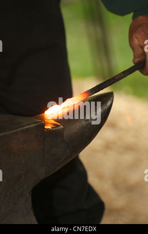 Craftsman working with fire beating iron Stock Photo - Alamy