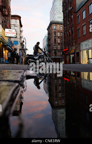 Biker reflection in a street puddle Stock Photo - Alamy
