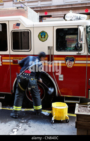 Fireman cleaning fire truck Stock Photo - Alamy