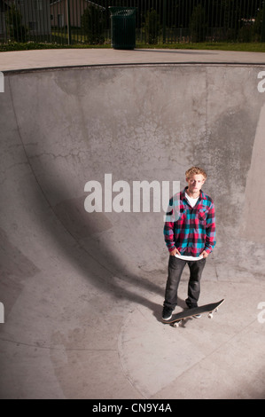 Full body of male skater in casual clothes performing extreme trick on ...