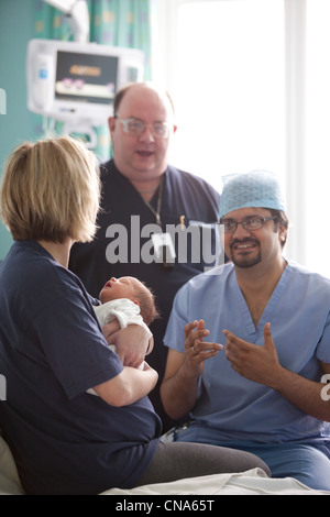 A senior midwife with a new mum UK Stock Photo - Alamy