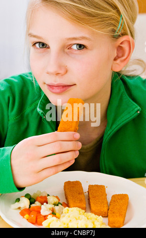 CHILD EATING FISH Stock Photo - Alamy