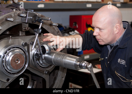Engineer repairing heavy mechanical equipment Stock Photo - Alamy