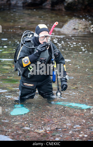 Underwatyer divers in scuba gear prepare to dive off the coast of f the ...