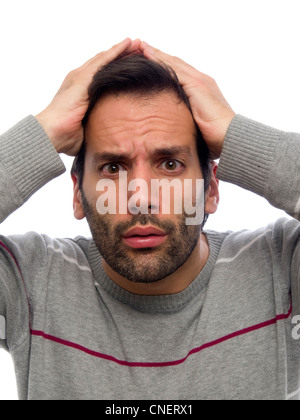 Portrait of skeptical young bearded man looking at camera isolated over ...