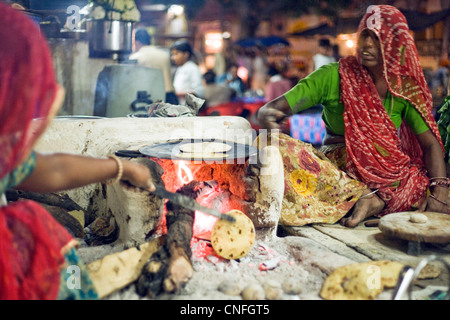 Indian woman cooking making roti bread in sitting down kitchen Jodhpur ...