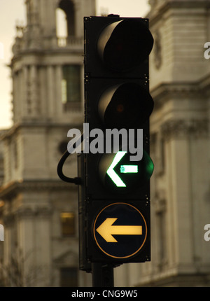 Traffic light with green arrow left and right turn signal against blue ...