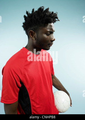 Young emotional man, looking down at pda on beige background Stock ...