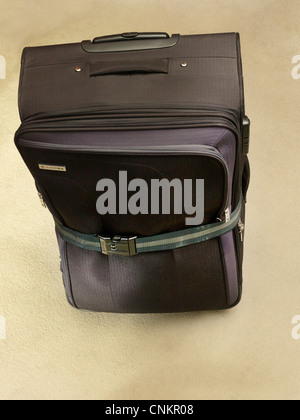A Strap Tied Tight Around A Full Black Suitcase Stock Photo - Alamy
