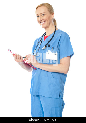 Confident senior female doctor posing and smiling, she is holding a ...