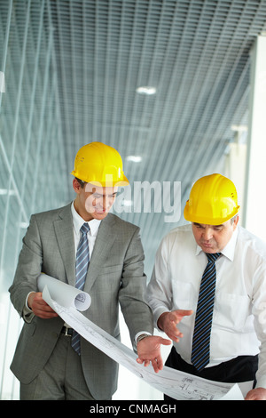 Two architects discussing construction project Stock Photo - Alamy