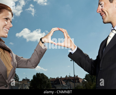 Hands of business people in circle make victory sign for success and ...