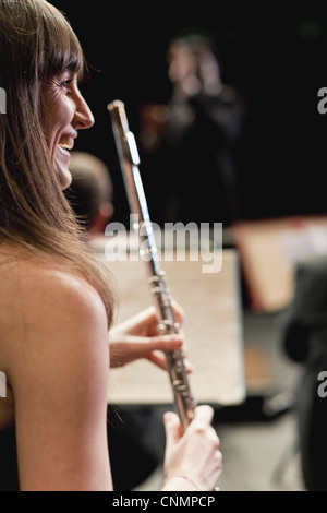 Flute player in orchestra Stock Photo - Alamy