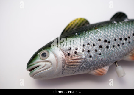 Fish out of water - a toy clockwork fish on a white background Stock ...