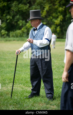 A man dressed in vintage uniform as scorekeeper for vintage baseball ...