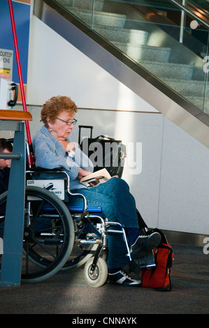 AIRPORT WHEELCHAIR Independent elderly woman waiting on airport ...