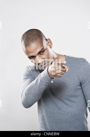 Cropped view of man pointing with finger while using laptop with ...