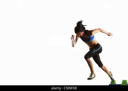 Sprinter taking off from starting block Stock Photo - Alamy