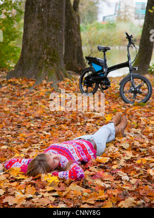 plant with green leaves lying down on a red background with copy space ...