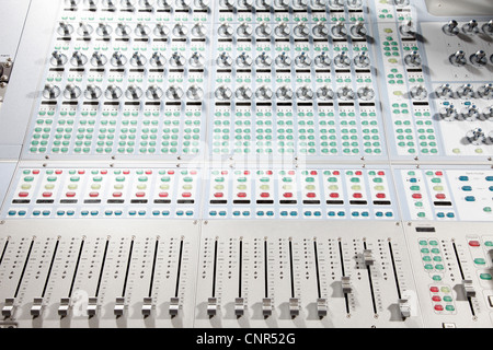 Inside a music recording studio with mixing desk and recording ...