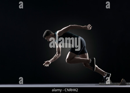 Sprinter leaving the starting block Stock Photo - Alamy