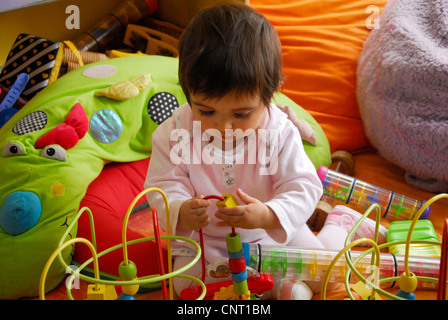 TODDLER IN PLAYGROUND EXPLORING THE TOY Stock Photo - Alamy