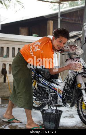 Asian man washing motorbike with soap at service station Stock Photo ...