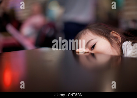 children looking over table edge Stock Photo - Alamy