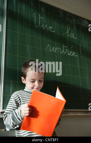 smiling kid hold school blackboard for copy space showing ok gesture ...