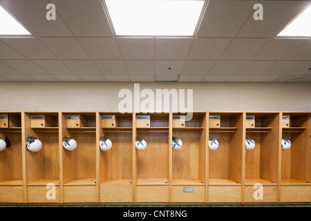Football helmets hanging in locker room Stock Photo - Alamy