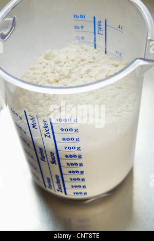 Flour in a measuring cup Stock Photo - Alamy
