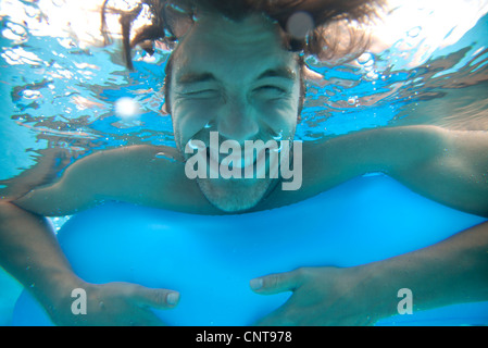 Man floating underwater in pool Stock Photo - Alamy