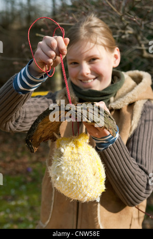 self-made dispenser for nesting material hanging from a branch Stock ...