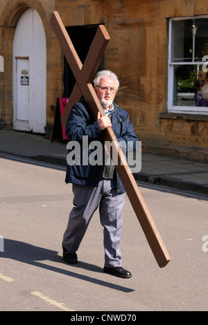 Christian Man carrying the Cross to mark the crucifixion of Jesus at ...