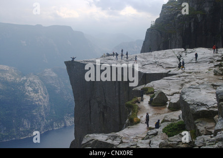 Tourists on rock platform Preikestolen, Ryfylke, Rogaland Province ...