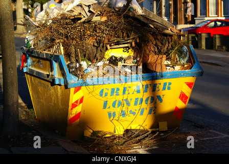 Overflowing rubbish skip Stock Photo - Alamy