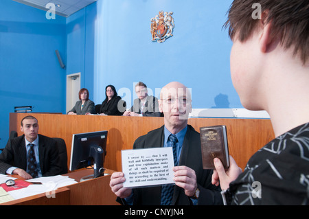 A witness swearing the oath in a magistrates' court Stock Photo - Alamy