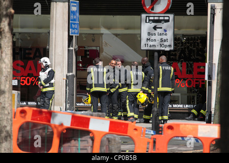 Fire crews standby on Tottenham Court Road as man lays siege to an ...