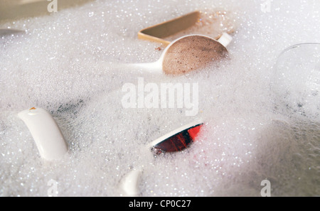 Dishes soaking in soapy water Stock Photo - Alamy