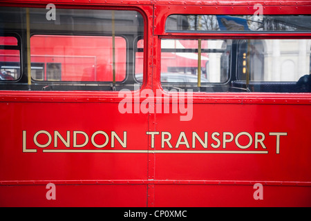 A sign for London Transport on the side of a old red route master bus ...