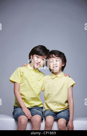 A boy and girl putting arms around on Stock Photo - Alamy