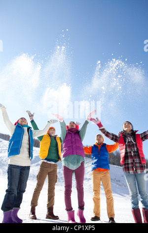 group of young people throwing snow in the air Stock Photo - Alamy