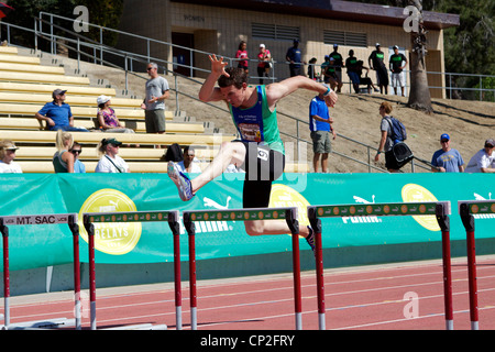 Male hurdler clearing hurdles Stock Photo - Alamy